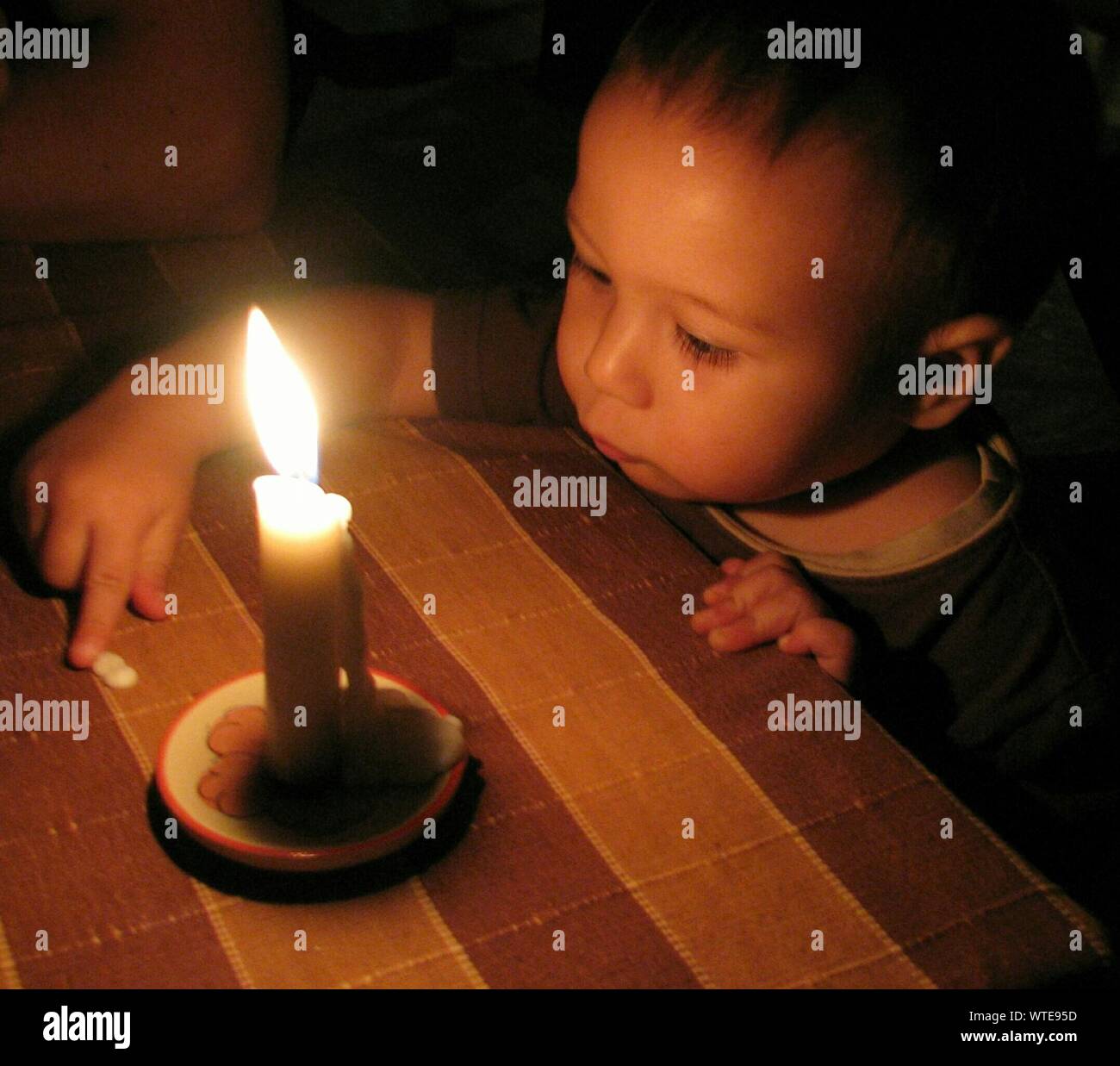 Light candle boy hi-res stock photography and images - Alamy