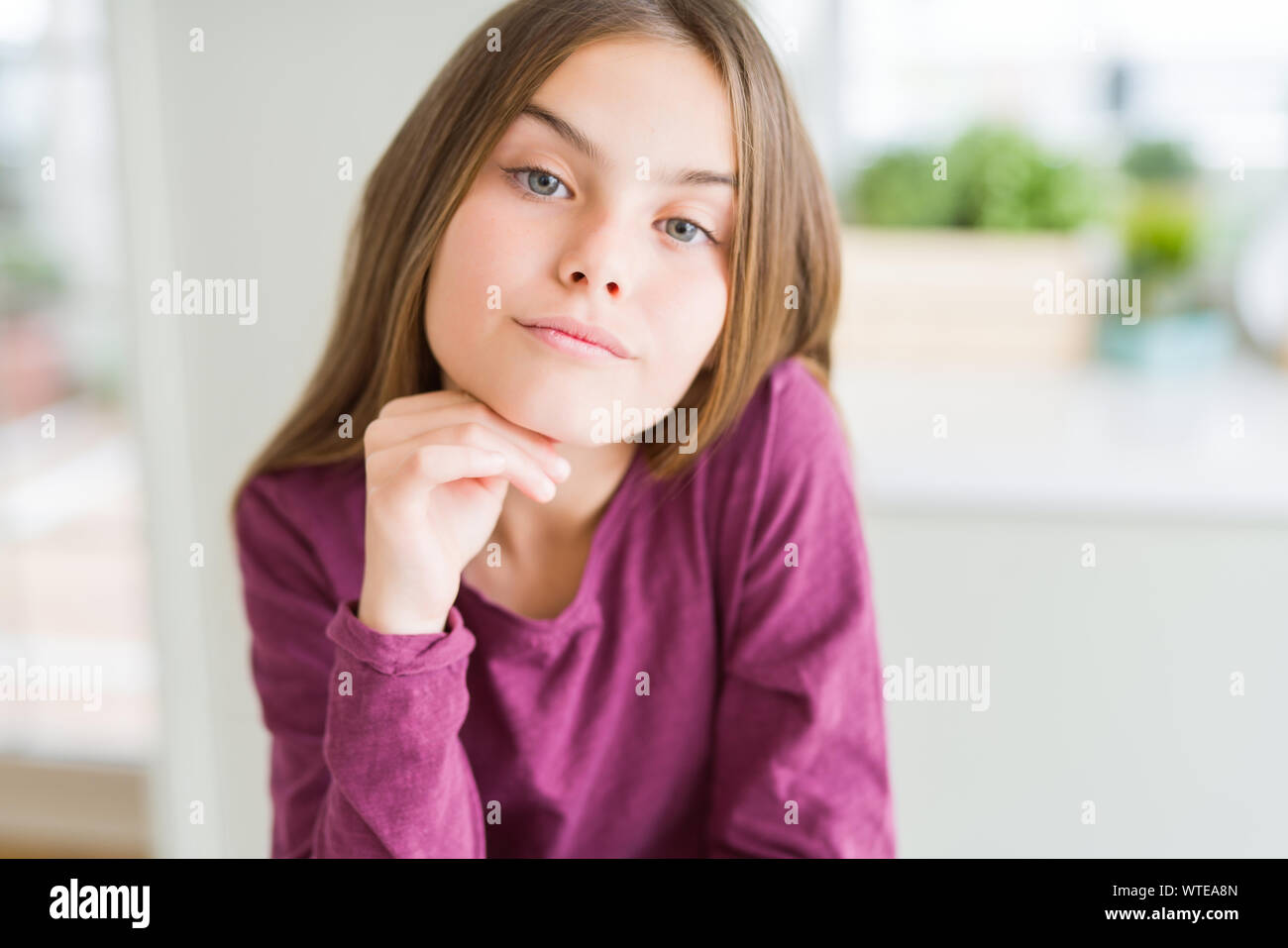 Beautiful young girl kid with hand on chin thinking about question ...