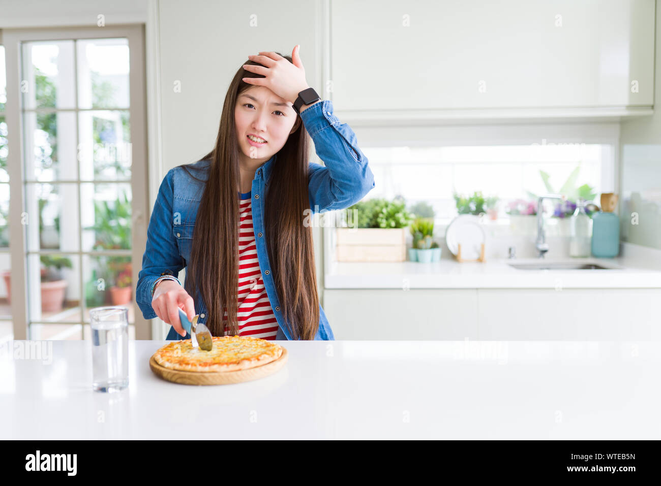 Beautiful Asian woman eating and cutting chesse pizza stressed with ...