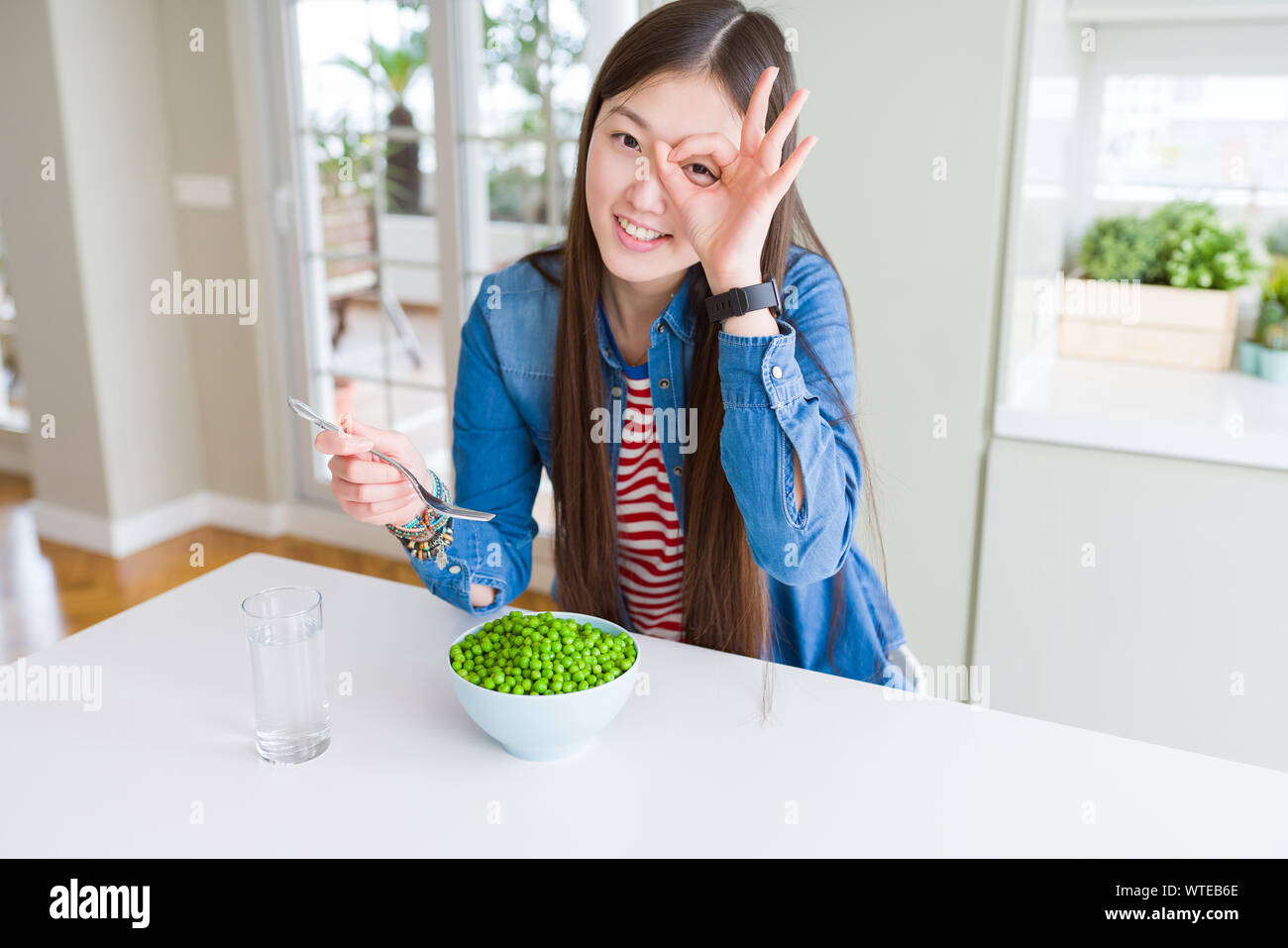 Beautiful Asian woman eating fresh green peas with happy face smiling ...