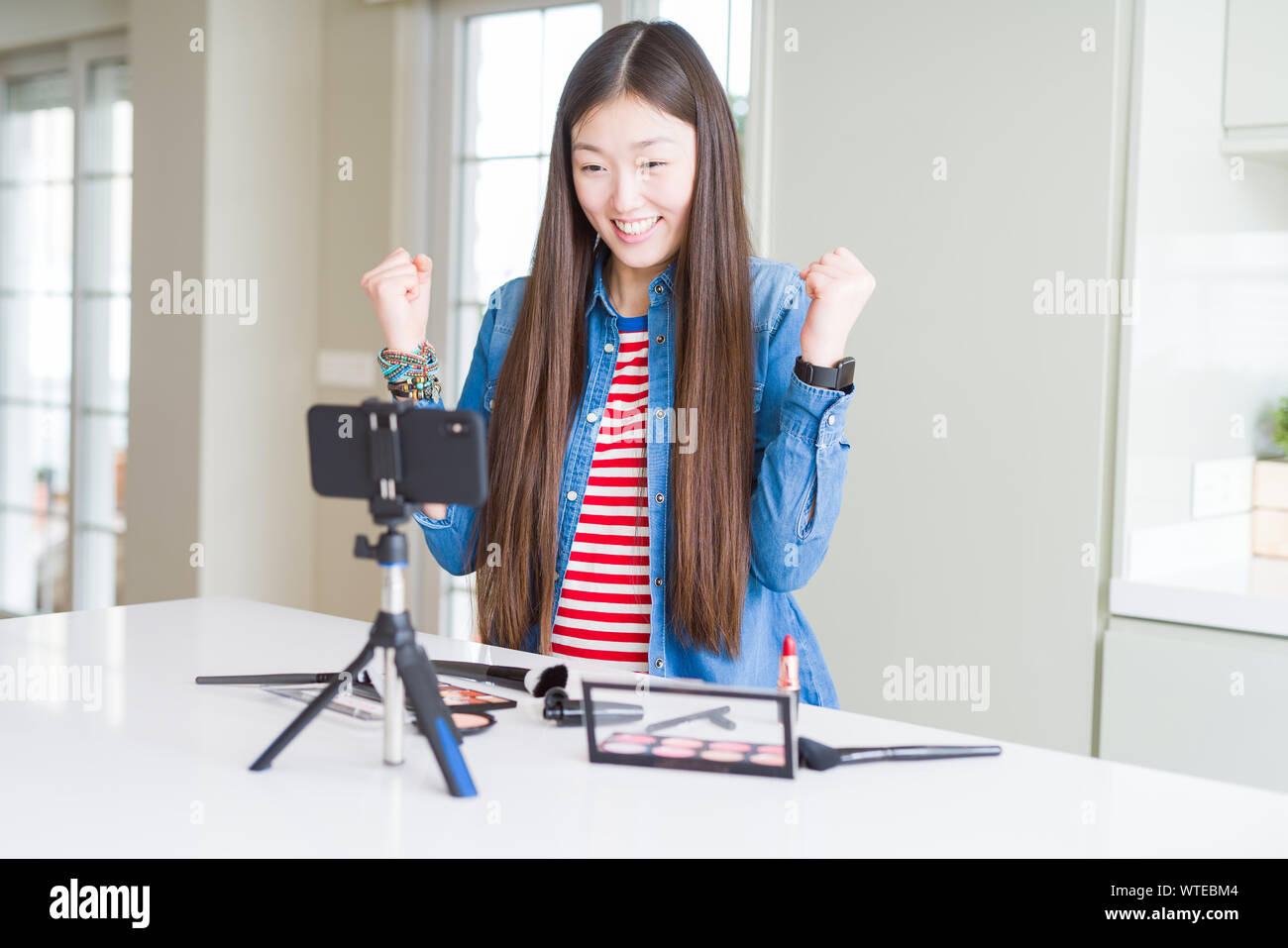 Beautiful Asian influencer woman recording make up tutorial using ...