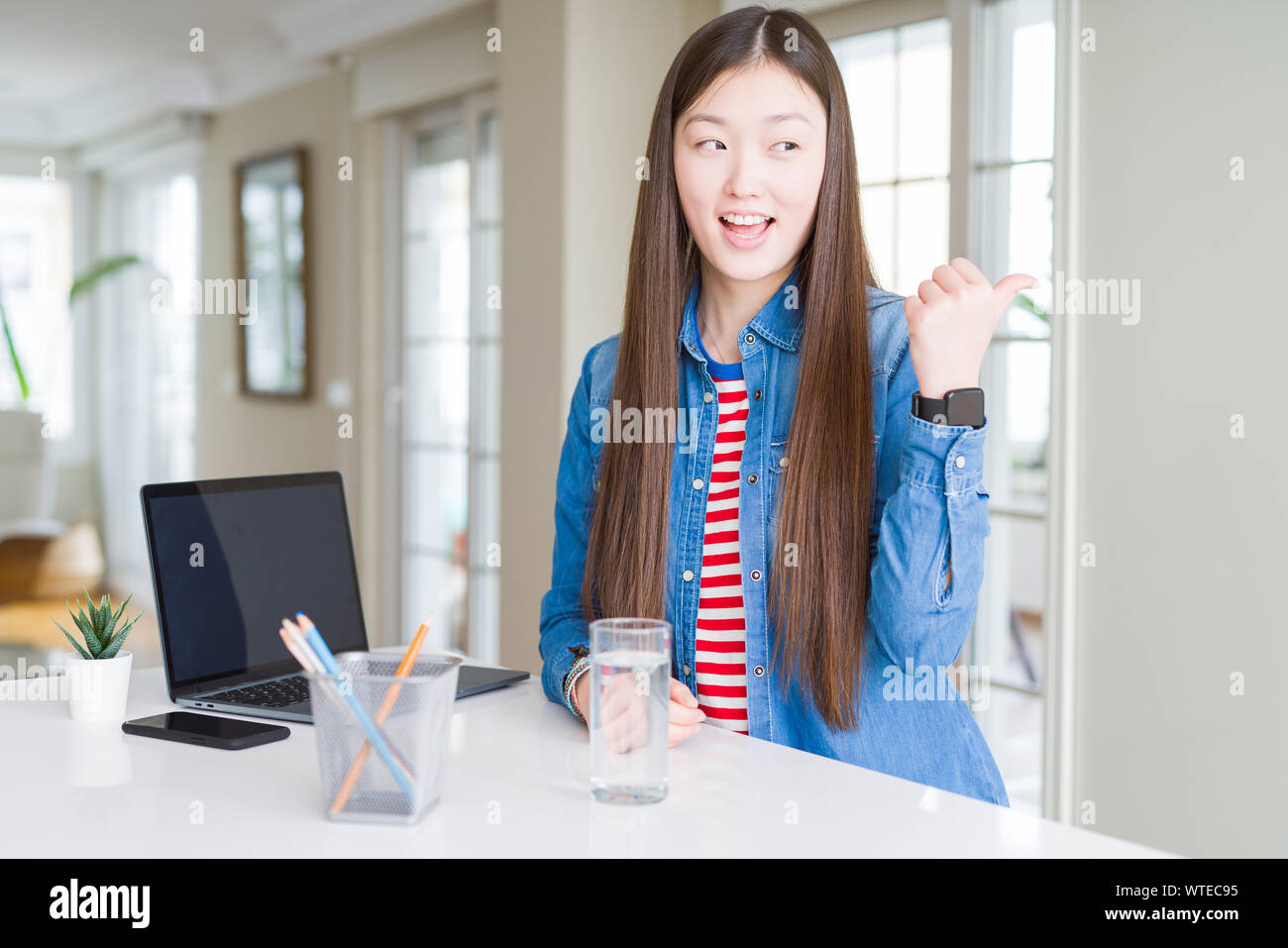 Beautiful Asian woman working using computer laptop smiling with happy ...