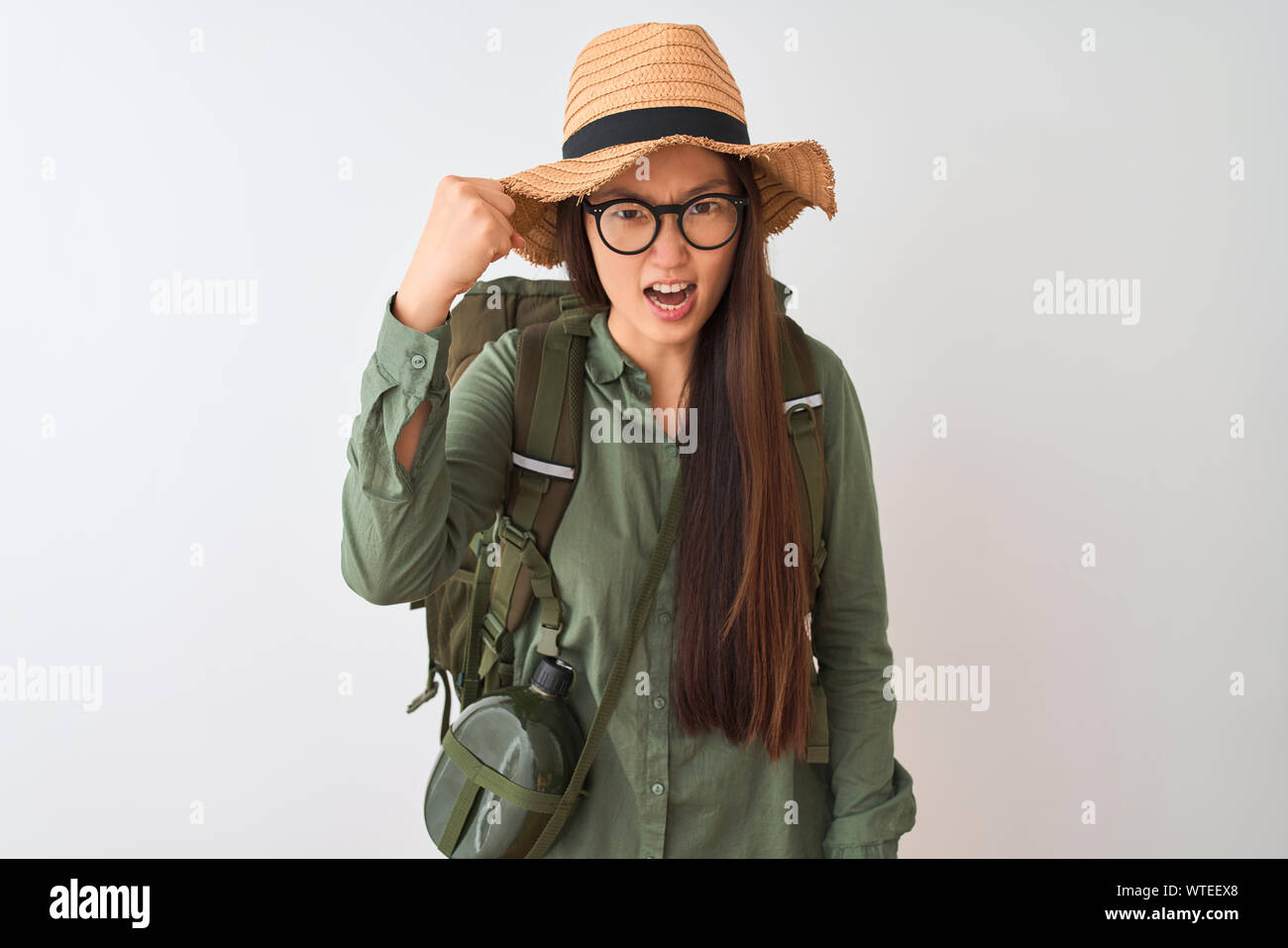 Chinese hiker woman wearing canteen hat glasses backpack over isolated ...