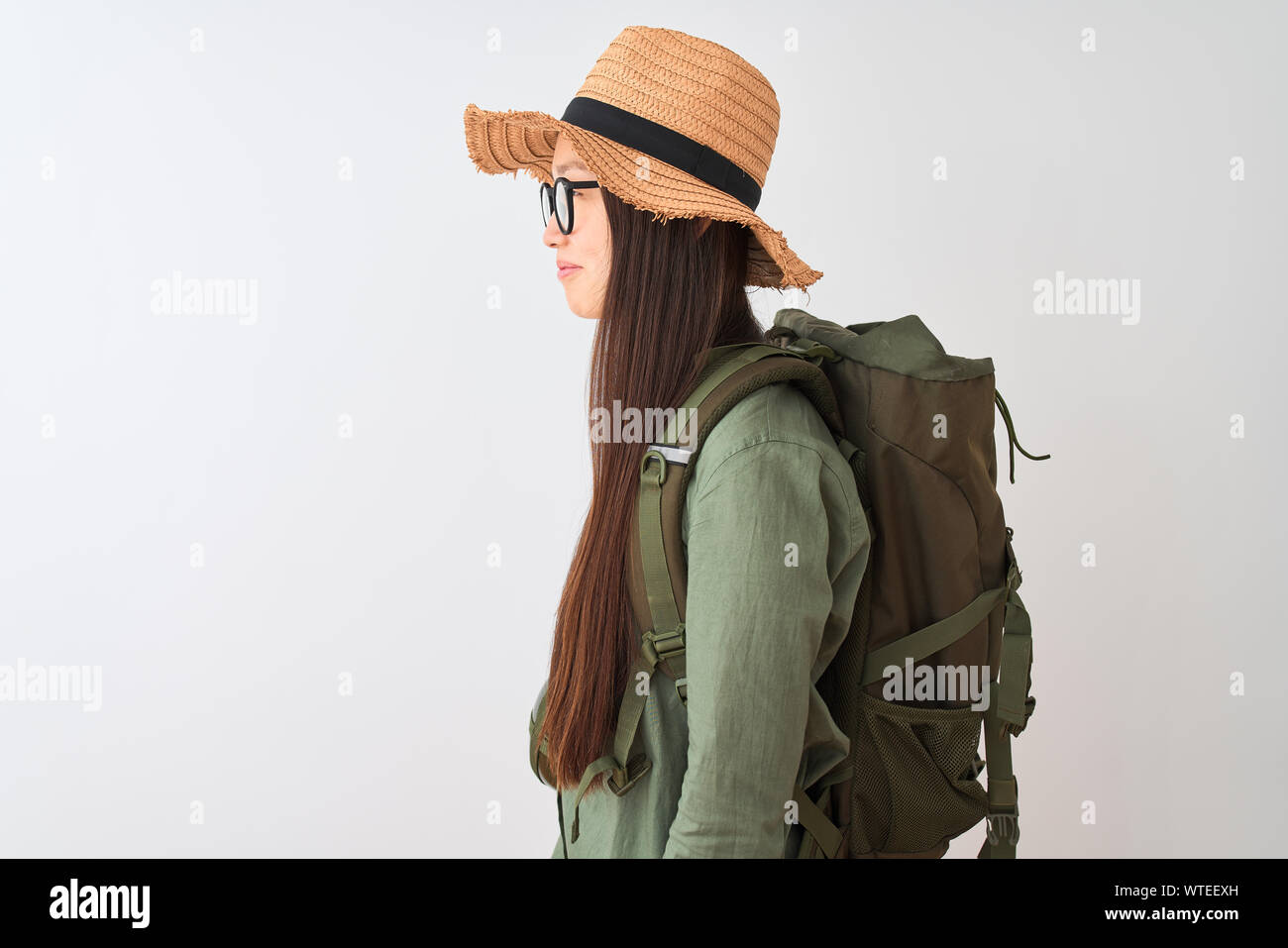Chinese hiker woman wearing canteen hat glasses backpack over isolated ...