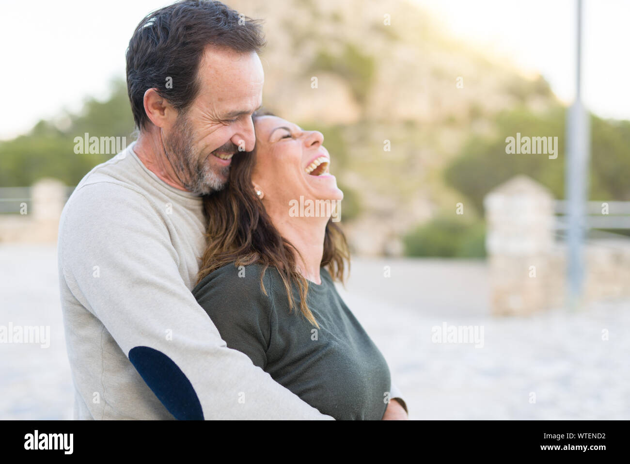 Romantic couple smiling, cuddling and hugging on a sunny day Stock ...
