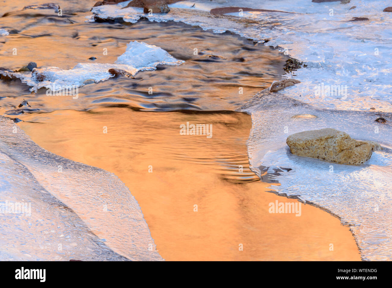 Ice formations along the Pine River with Zion Canyon wall reflections ...