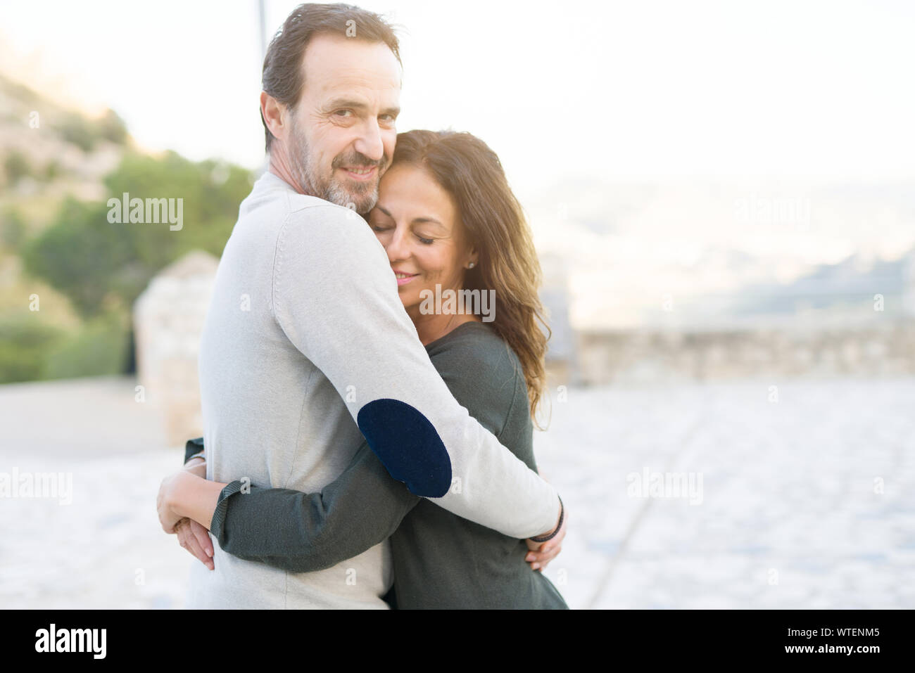 Romantic couple smiling, cuddling and hugging on a sunny day Stock ...