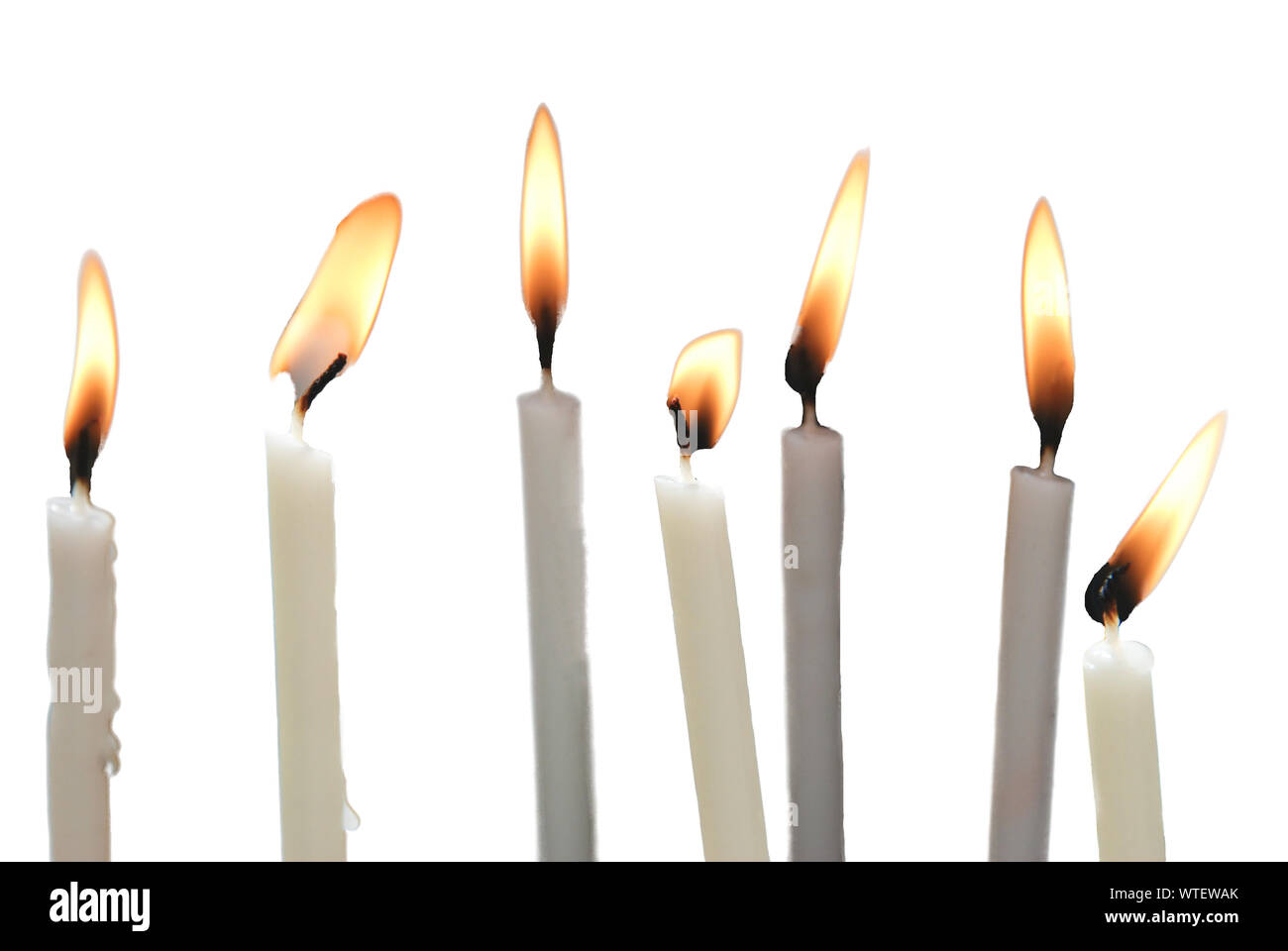 Many white candle on a isolated white background Stock Photo - Alamy