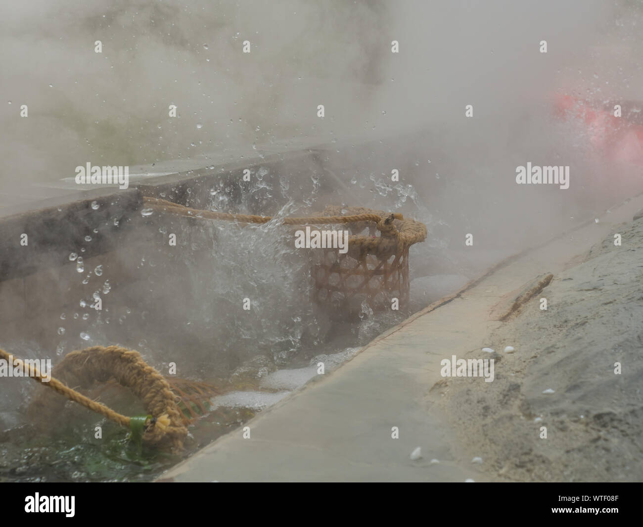 Eggs and vegetables being cooked in the water of hot springs in Taiping ...