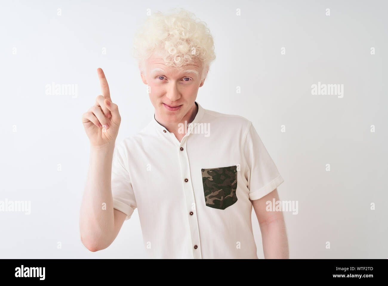 Young albino blond man wearing casual shirt standing over isolated ...