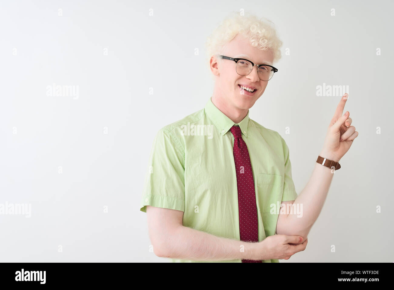 Young albino businessman wearing shirt and tie standing over isolated ...