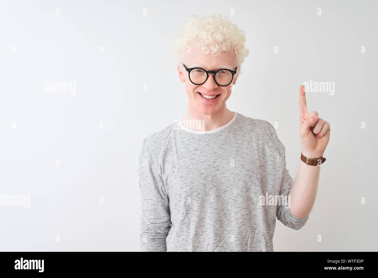Young albino blond man wearing striped t-shirt and glasses over ...