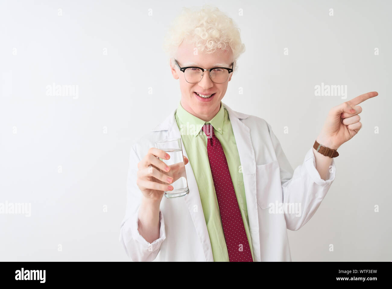 Albino scientist man wearing glasses holding glass of water over ...