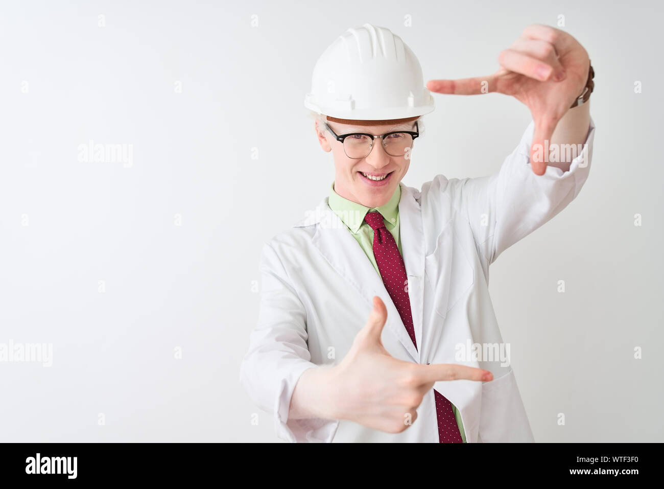 Albino scientist man wearing glasses and helmet standing over isolated ...