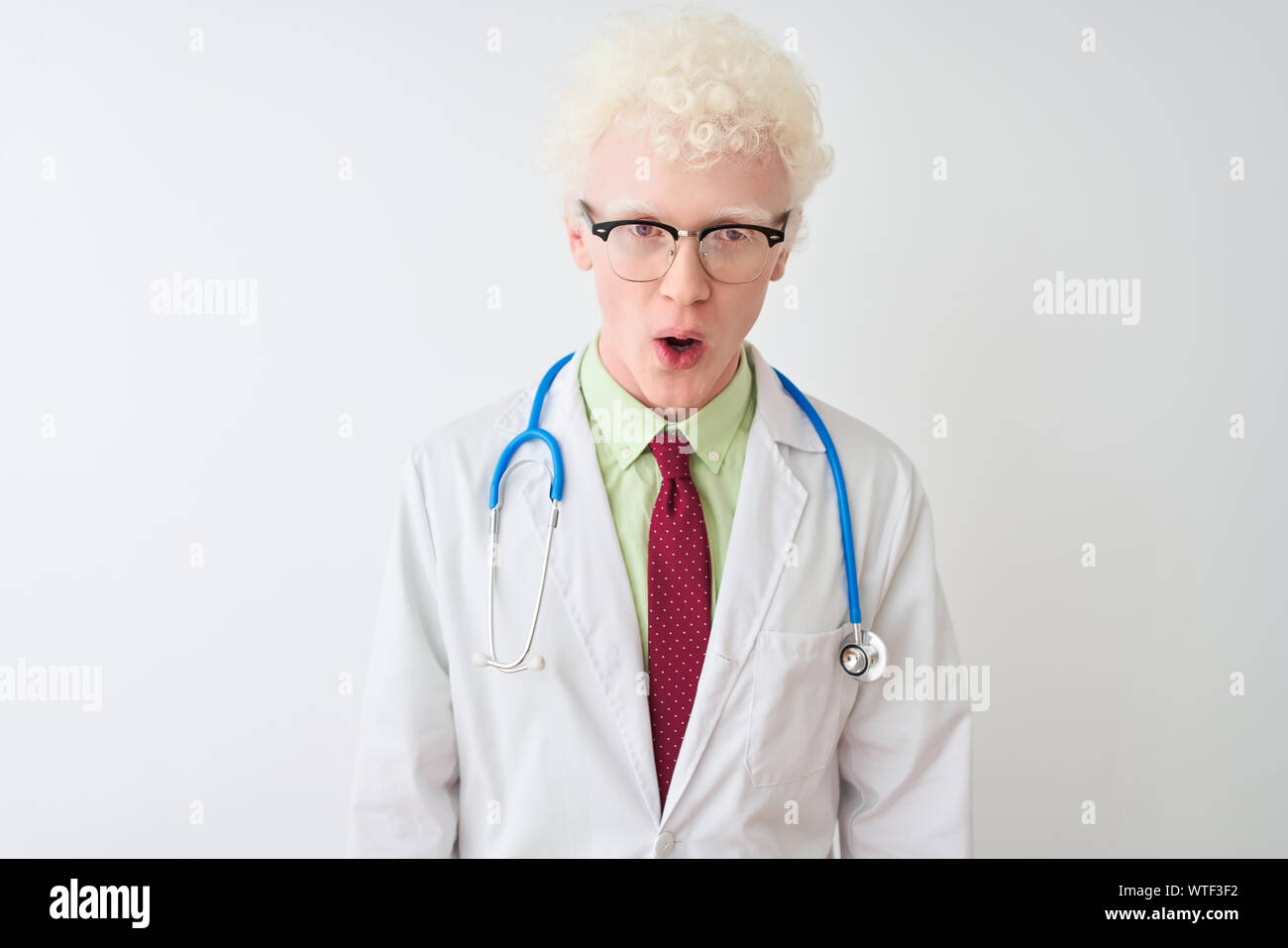 Young albino doctor man wearing stethoscope standing over isolated ...