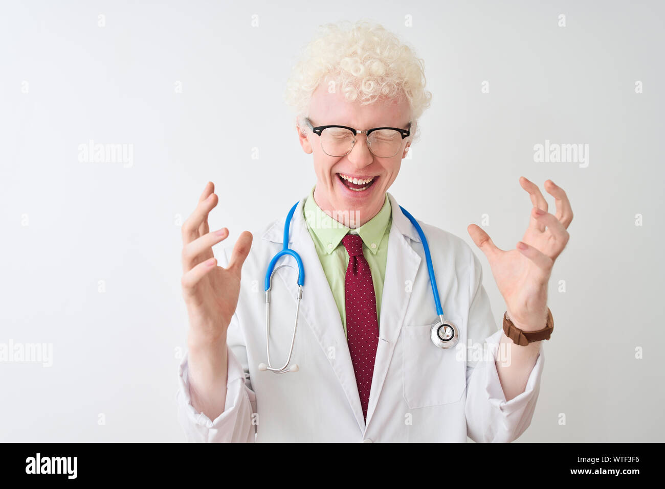 Young albino doctor man wearing stethoscope standing over isolated ...