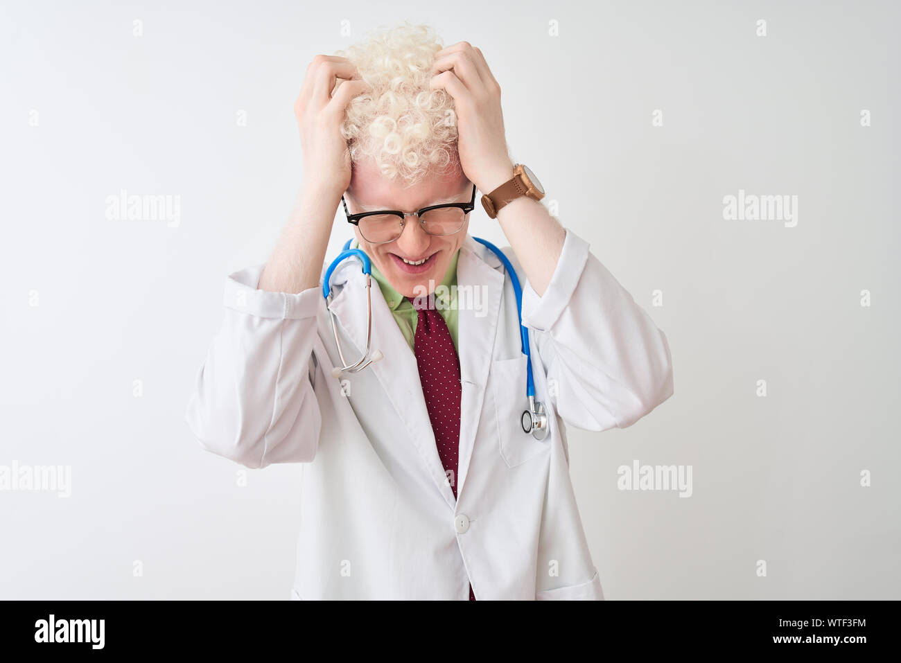 Young albino doctor man wearing stethoscope standing over isolated ...