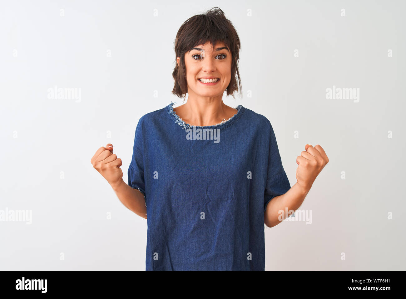 Young beautiful woman wearing denim dress standing over isolated white ...
