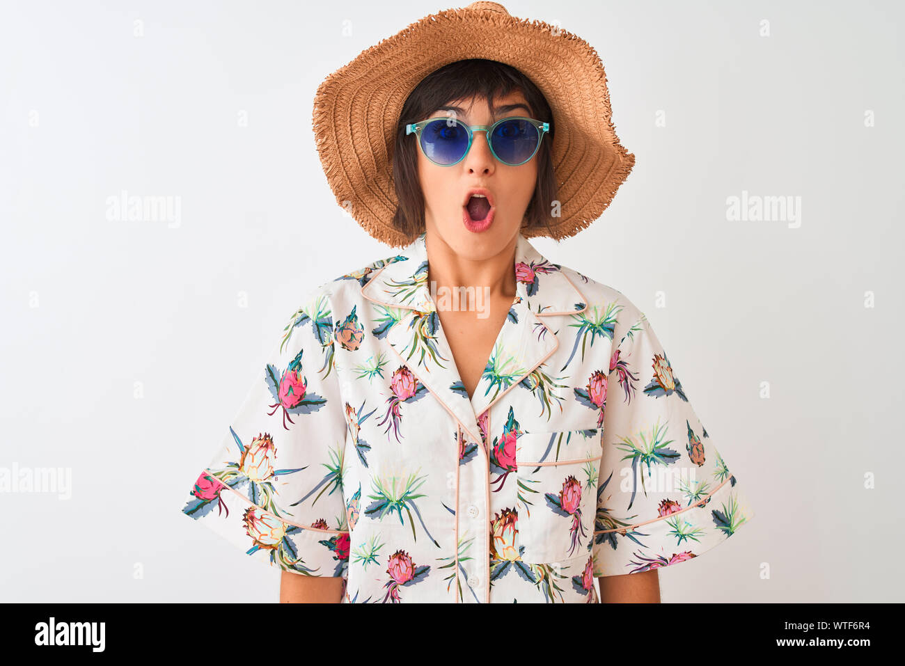 Woman on vacation wearing summer hat shirt and sunglasses over isolated ...