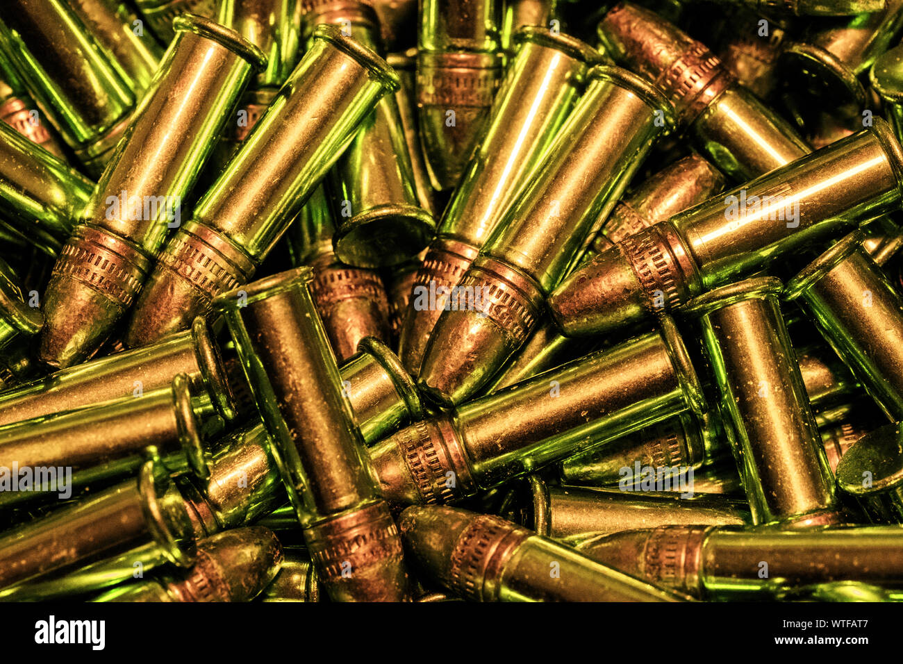 A group of .22 long rifle cartridges with abstract orange and green ...
