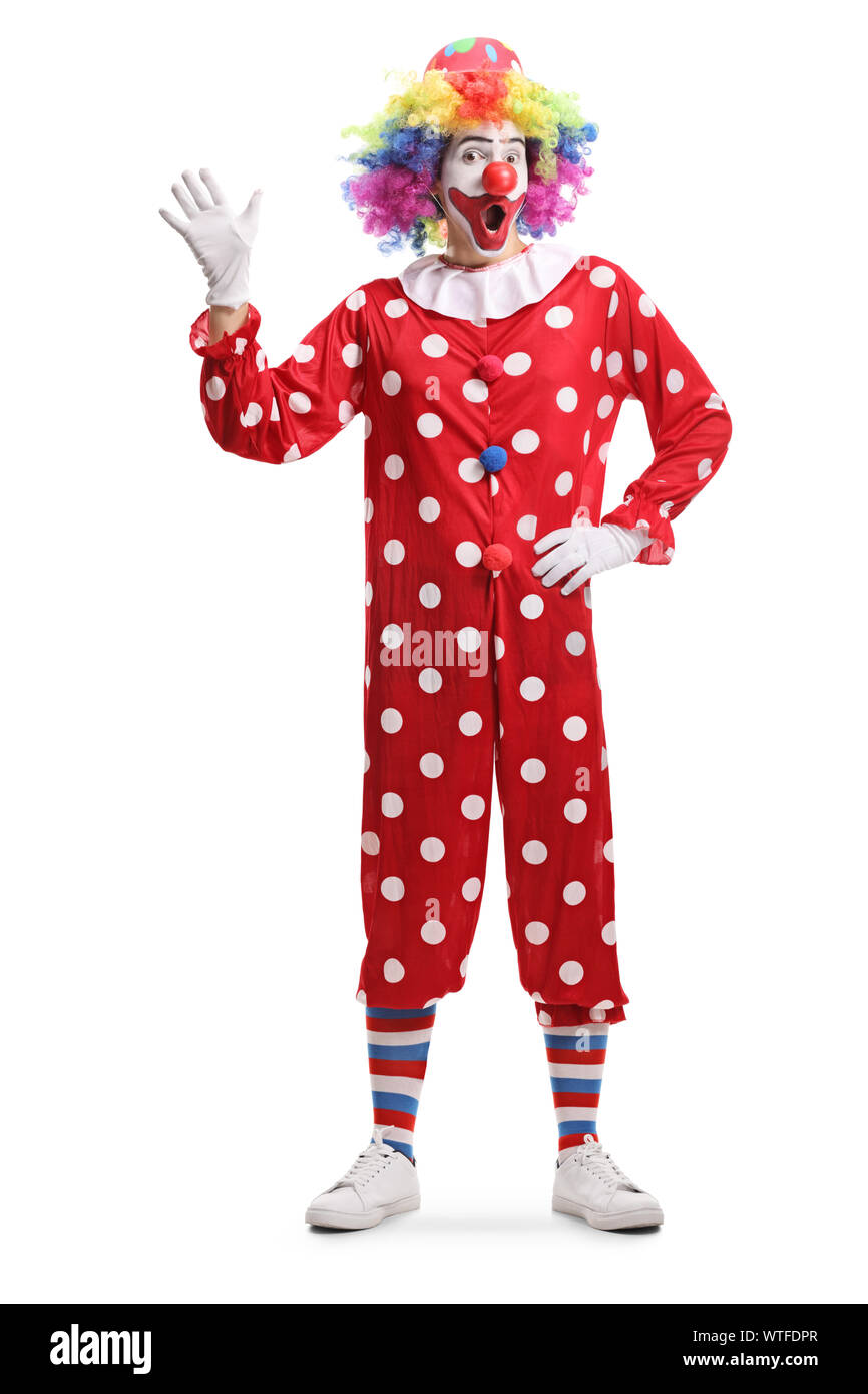 Full length portrait of a cheerful clown waving hello isolated on white ...