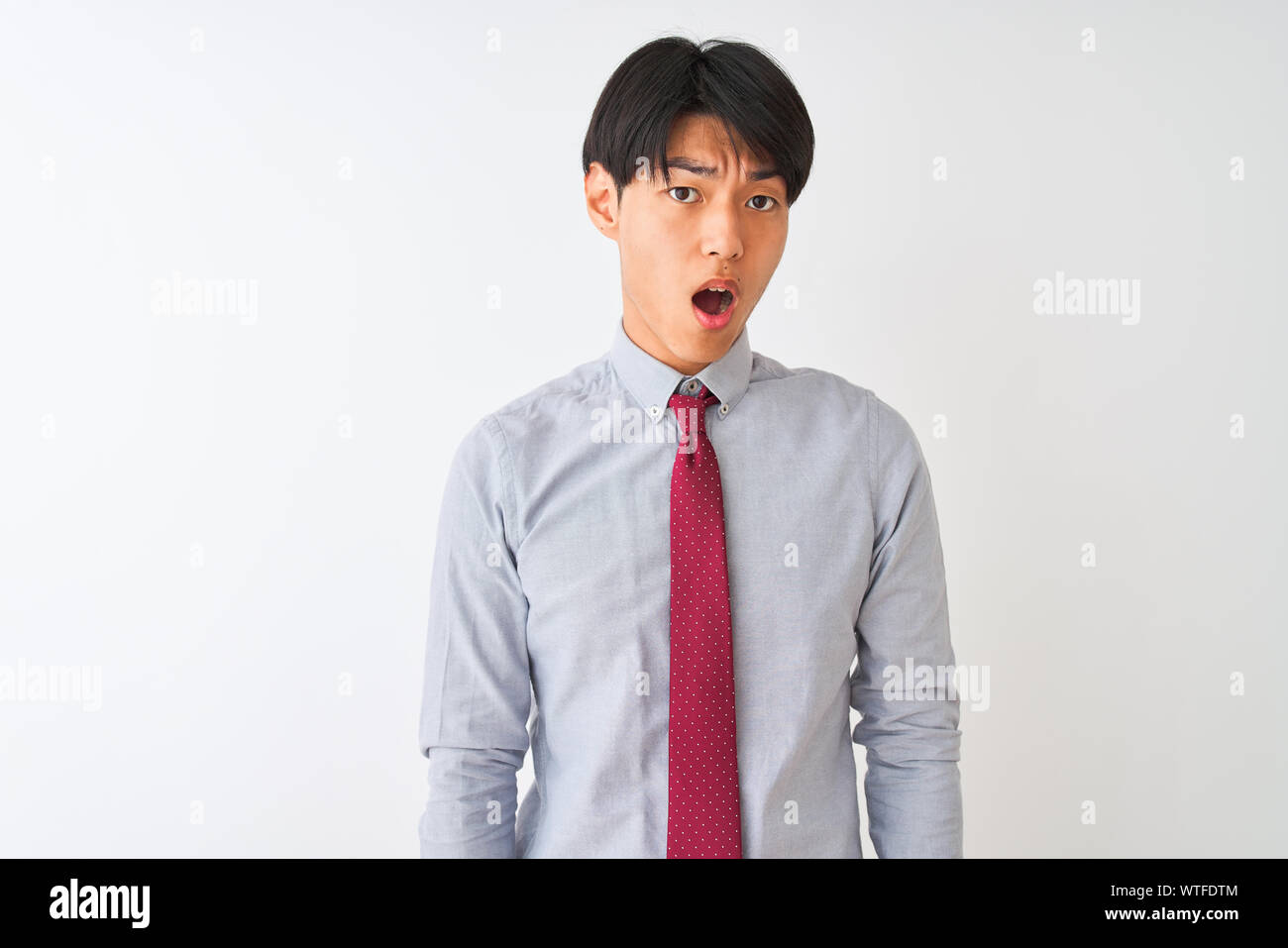 Chinese businessman wearing elegant tie standing over isolated white ...