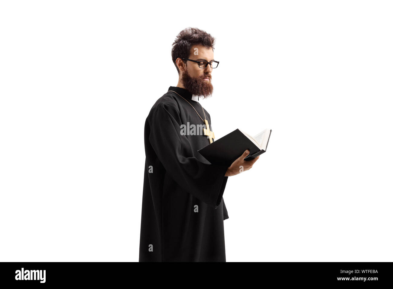 Priest standing and reading the Bible isolated on white background ...