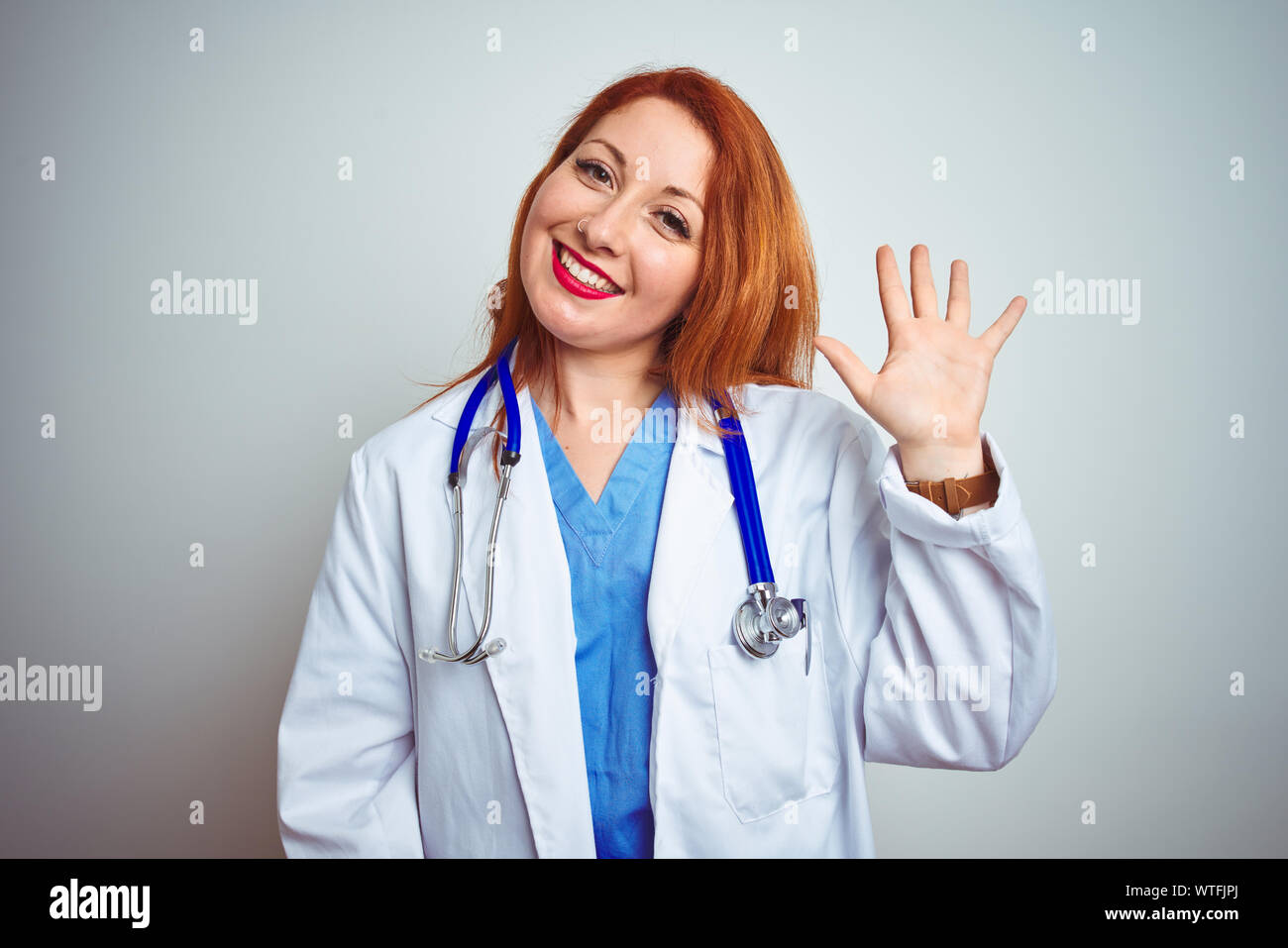 Young redhead doctor woman using stethoscope over white isolated ...