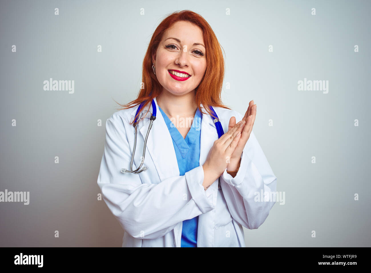 Young redhead doctor woman using stethoscope over white isolated ...