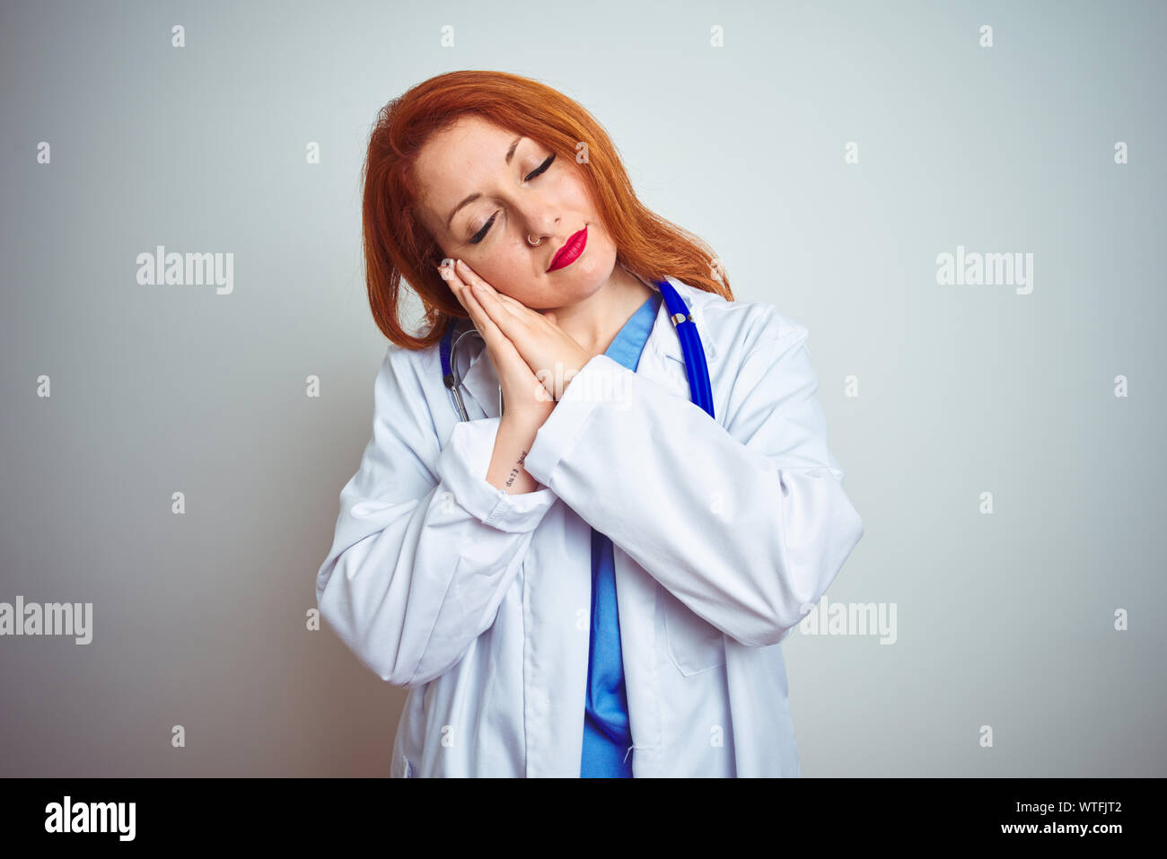 Young redhead doctor woman using stethoscope over white isolated ...