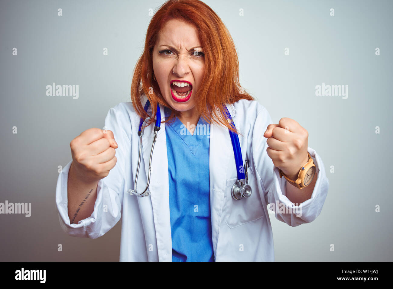 Young redhead doctor woman using stethoscope over white isolated ...