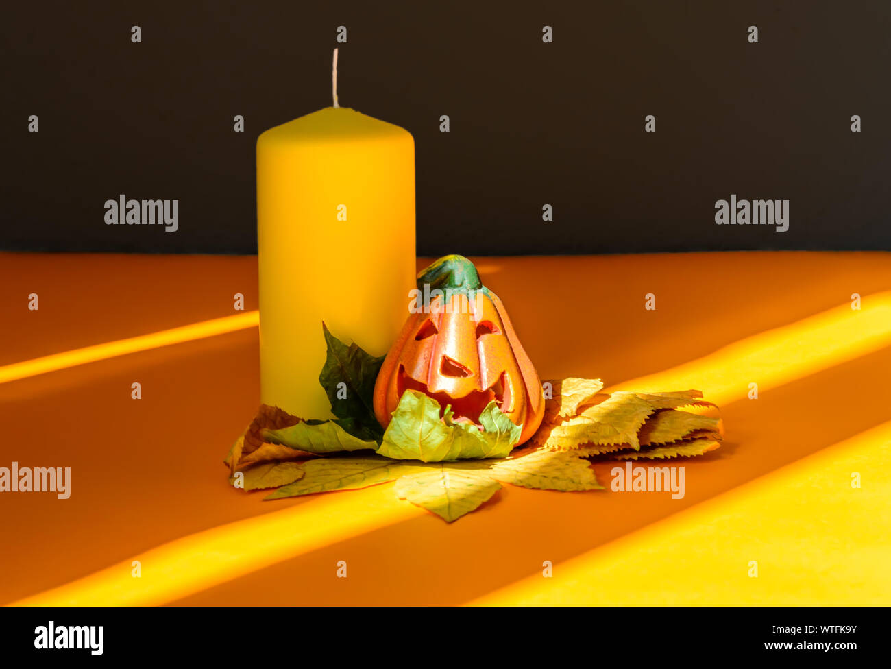 Ceramic Halloween pumpkin jack-o-lantern on dry autumn leaves, yellow ...