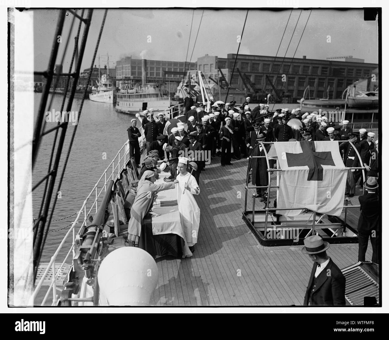 Miss Marjorie Wright pinning cross button on cook of Mayflower, 11/5/24 ...