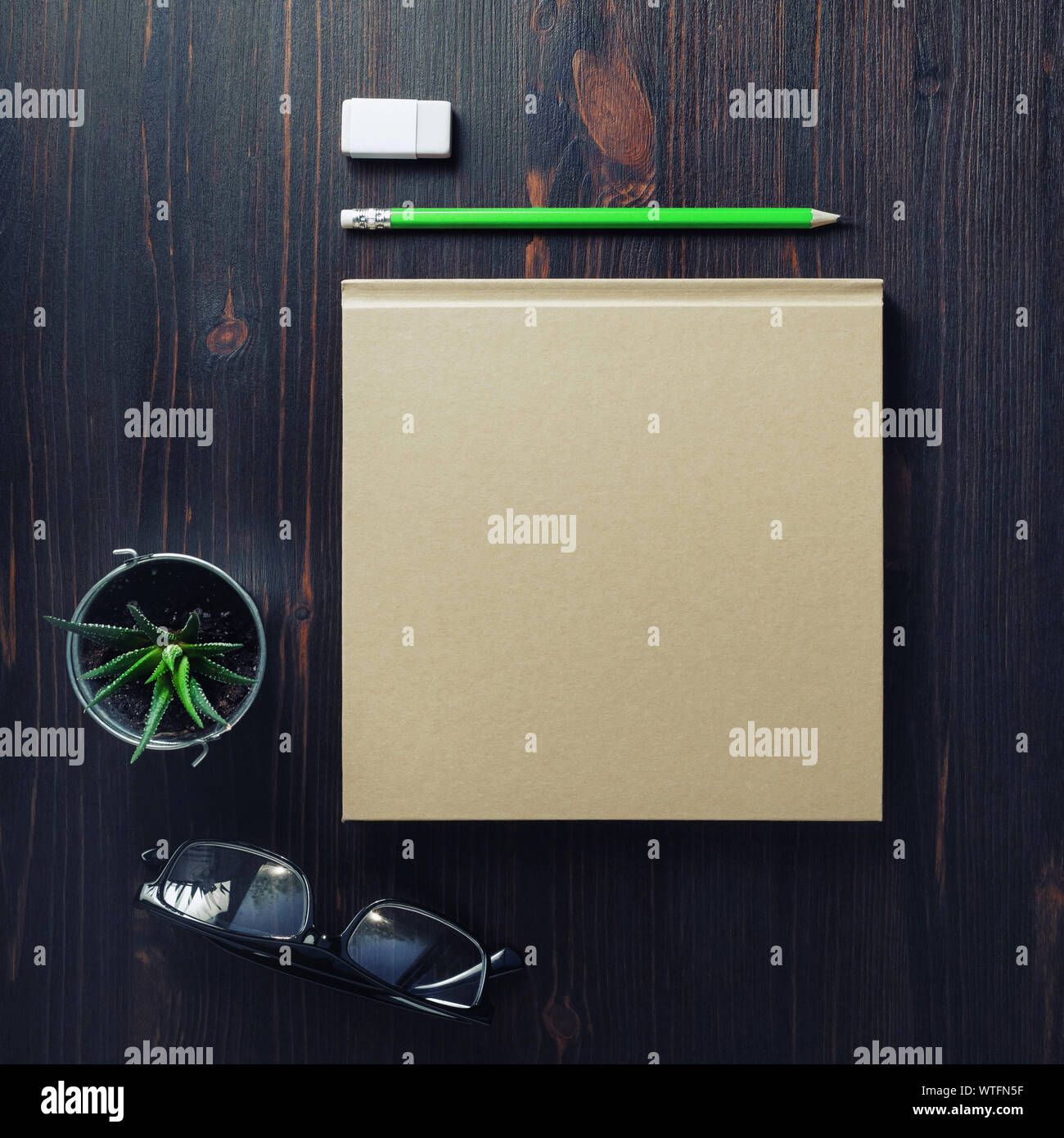 Blank closed booklet and stationery on vintage wood table background ...