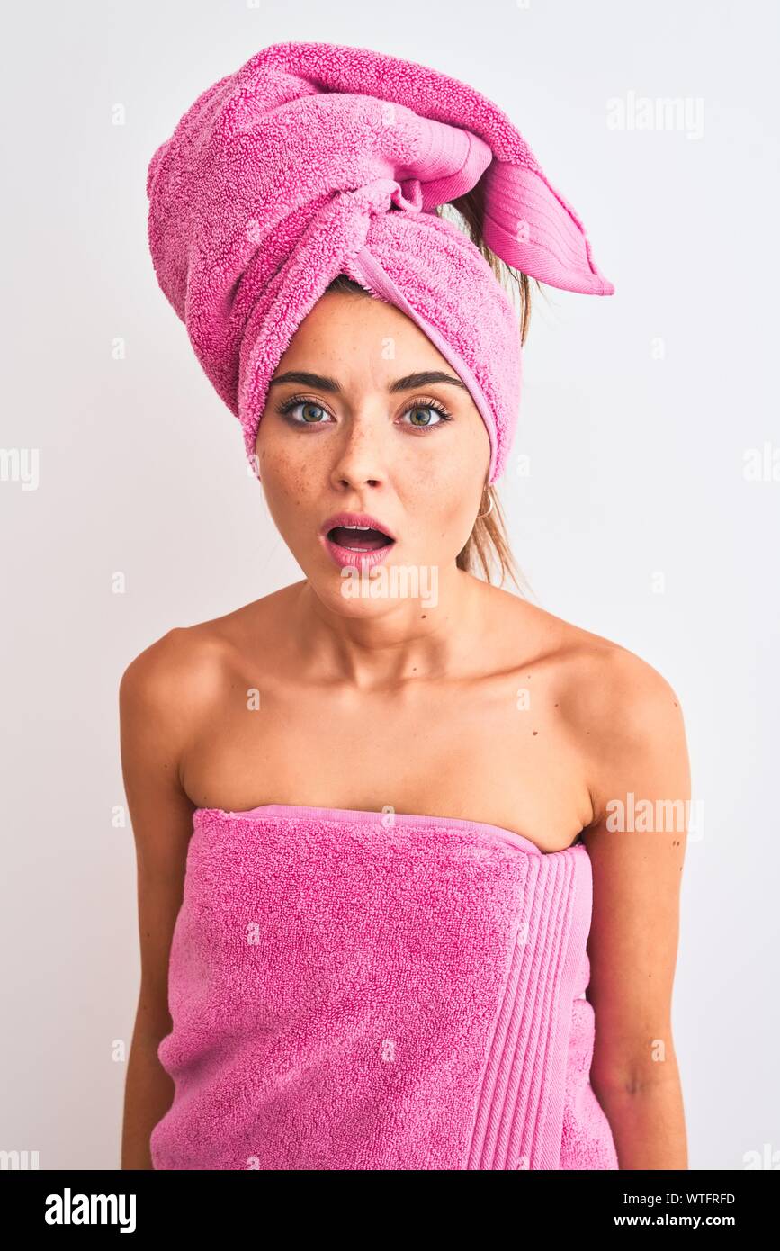 Young beautiful woman wearing shower towel after bath over isolated ...