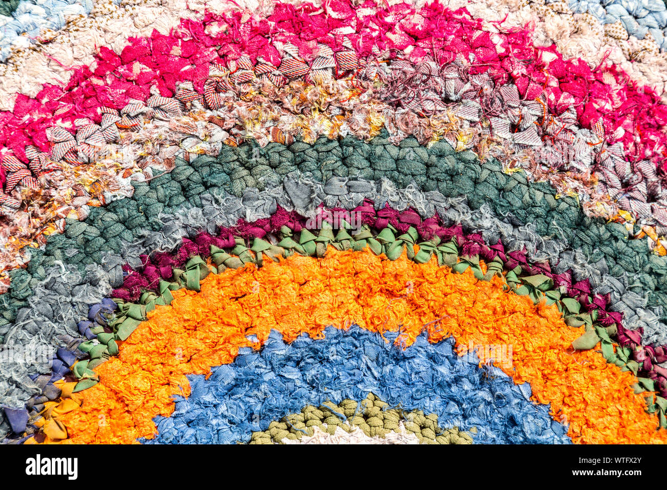 Old handicraft rug made from strips of cloth as background. Texture of ...