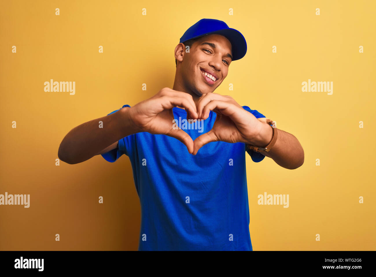 Young handsome arab delivery man standing over isolated yellow ...