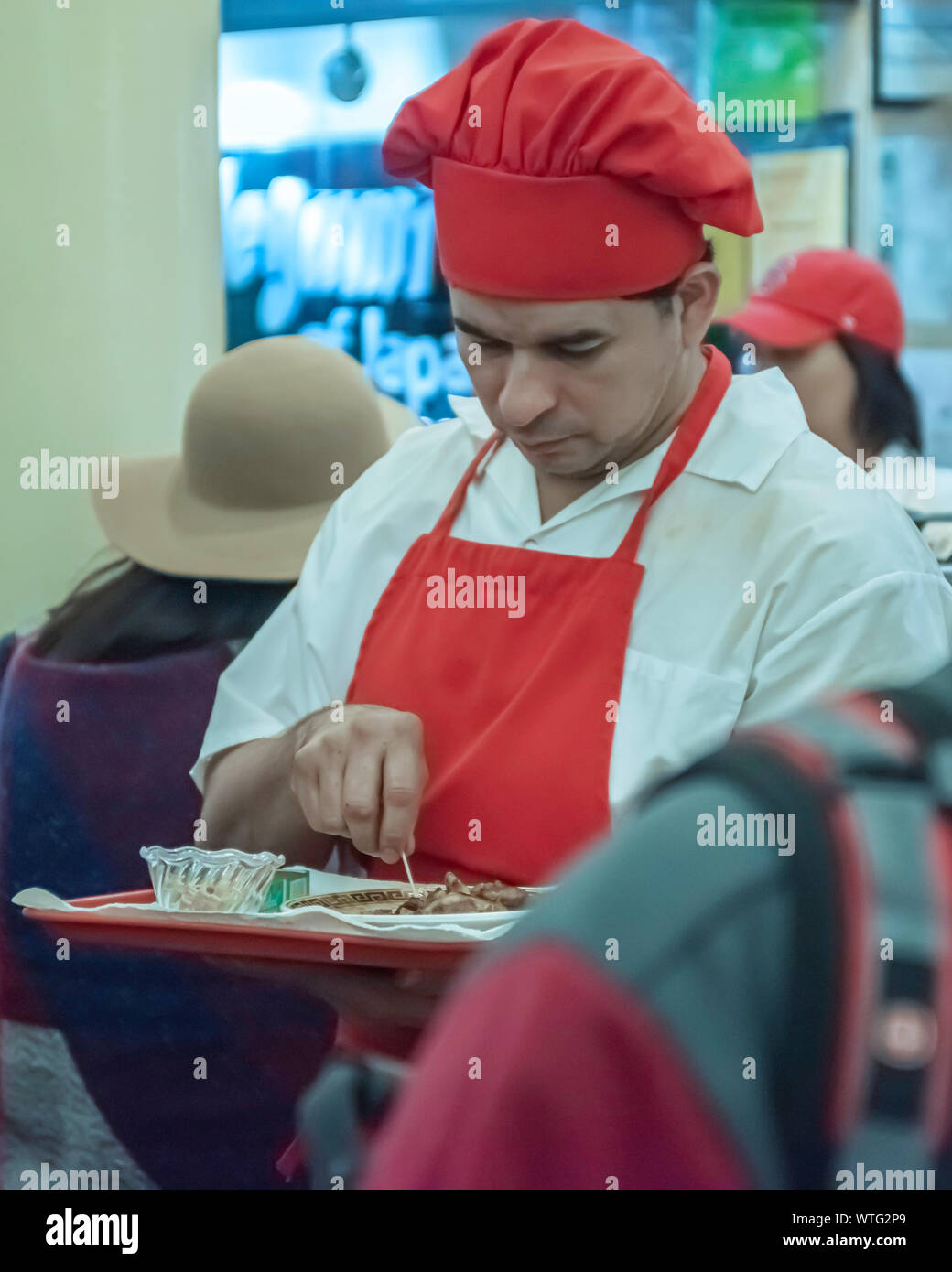 Boston, Massachusetts USA. 10/31/2015. Server giving out sample food at ...