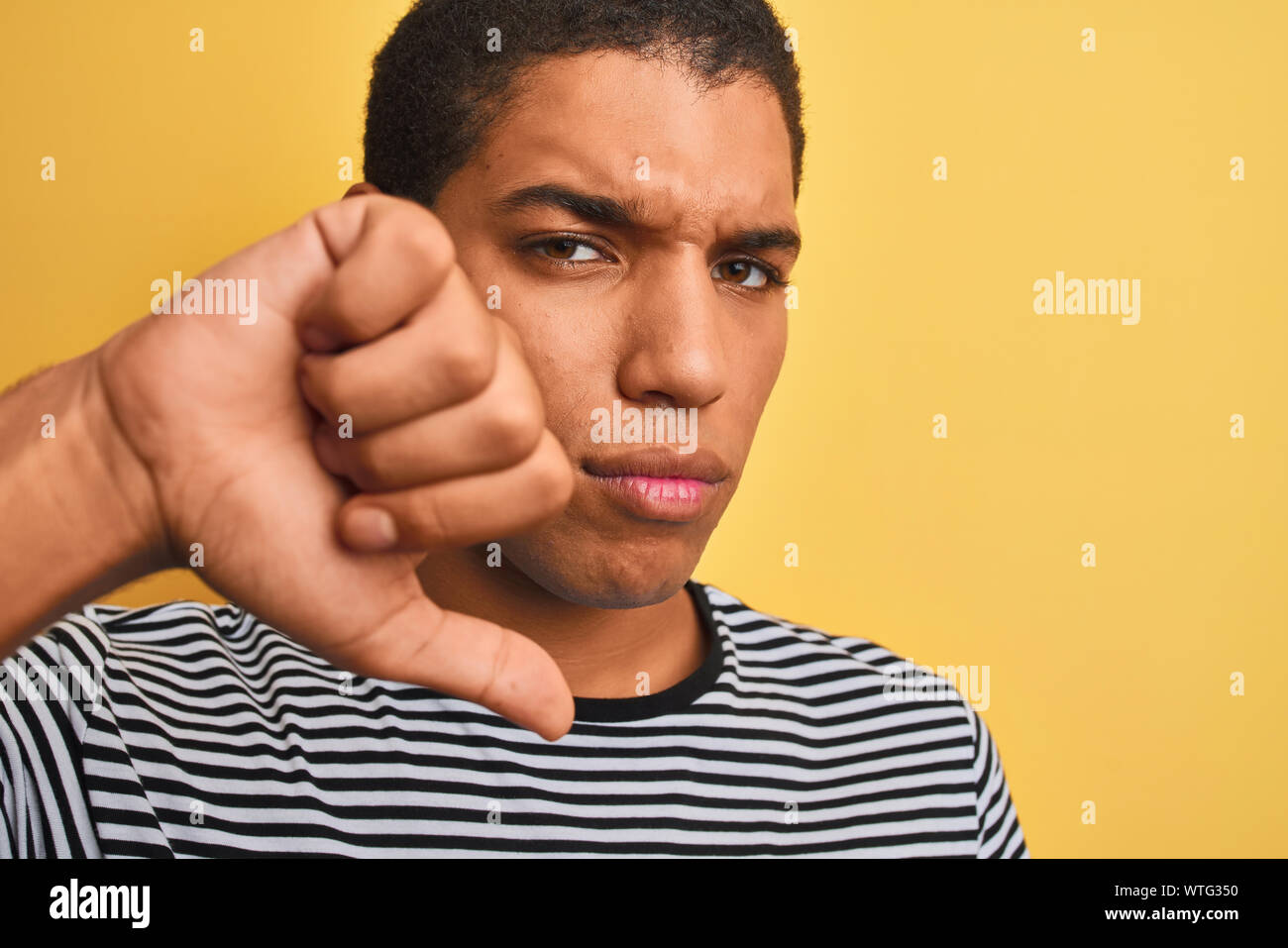 Young handsome arab man wearing navy striped t-shirt over isolated ...