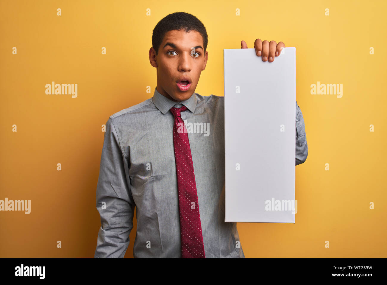Young handsome arab businessman holding banner standing over isolated ...