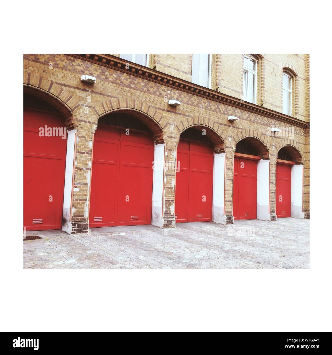 Red brick wall with door Cut Out Stock Images & Pictures - Alamy