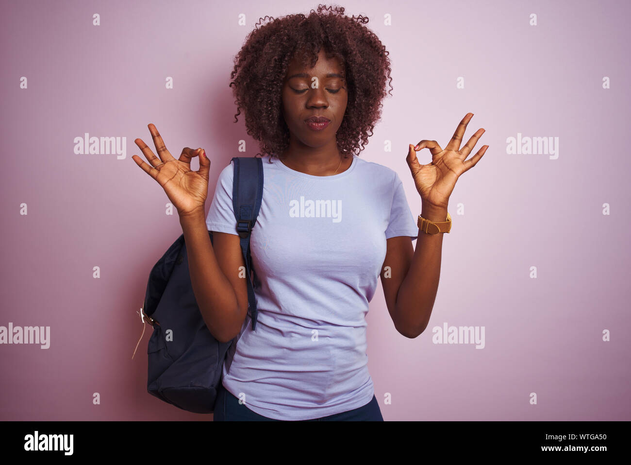 Young african afro tourist woman wearing backpack standing over ...