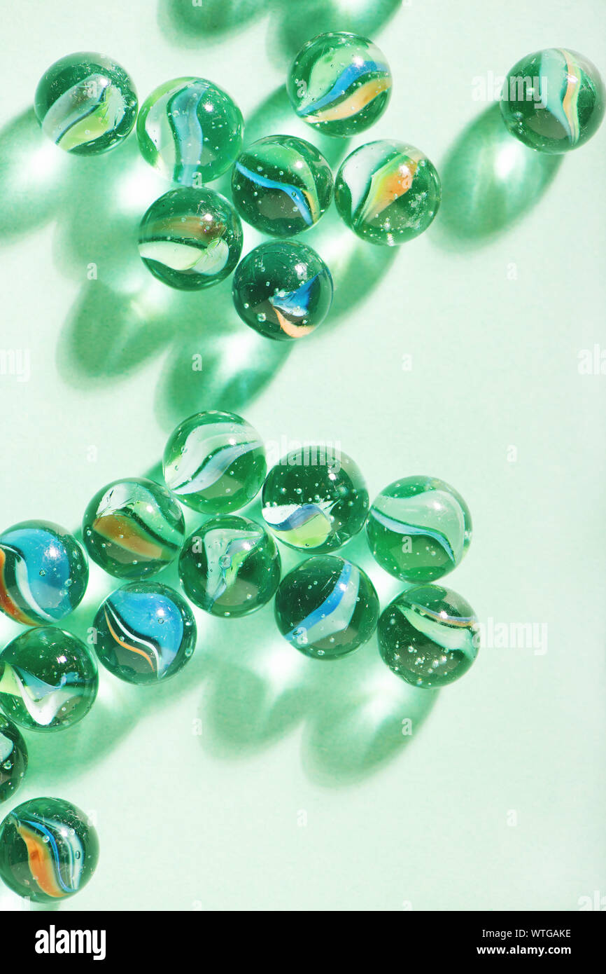 Close up view of little colored glass balls on mint background Stock ...