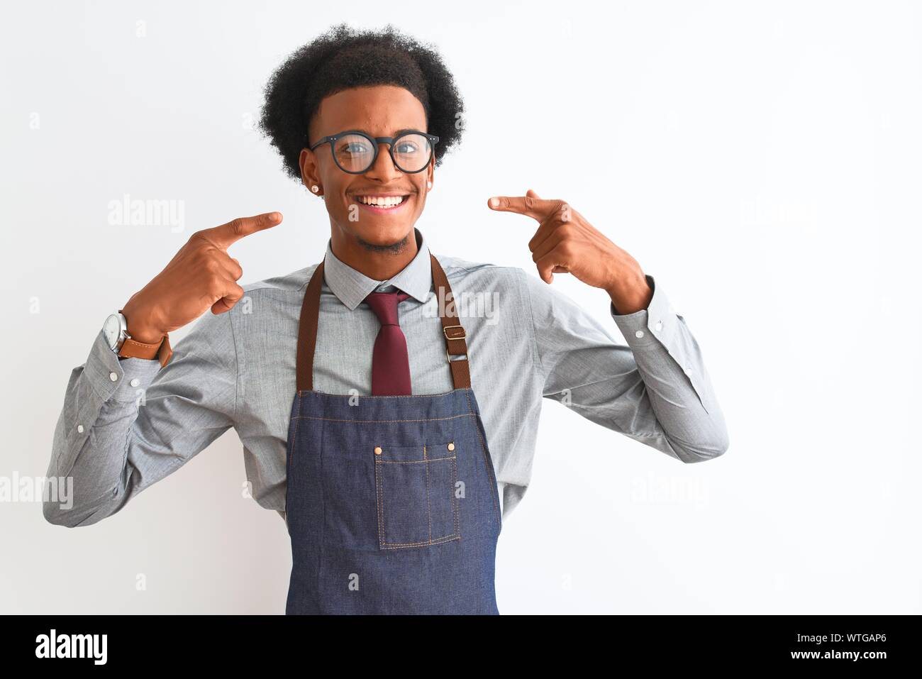 Young african american shopkeeper man wearing apron glasses over ...