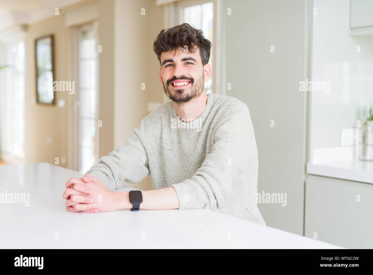 Handsome young man smiling cheerful at the camera with a big smile on ...
