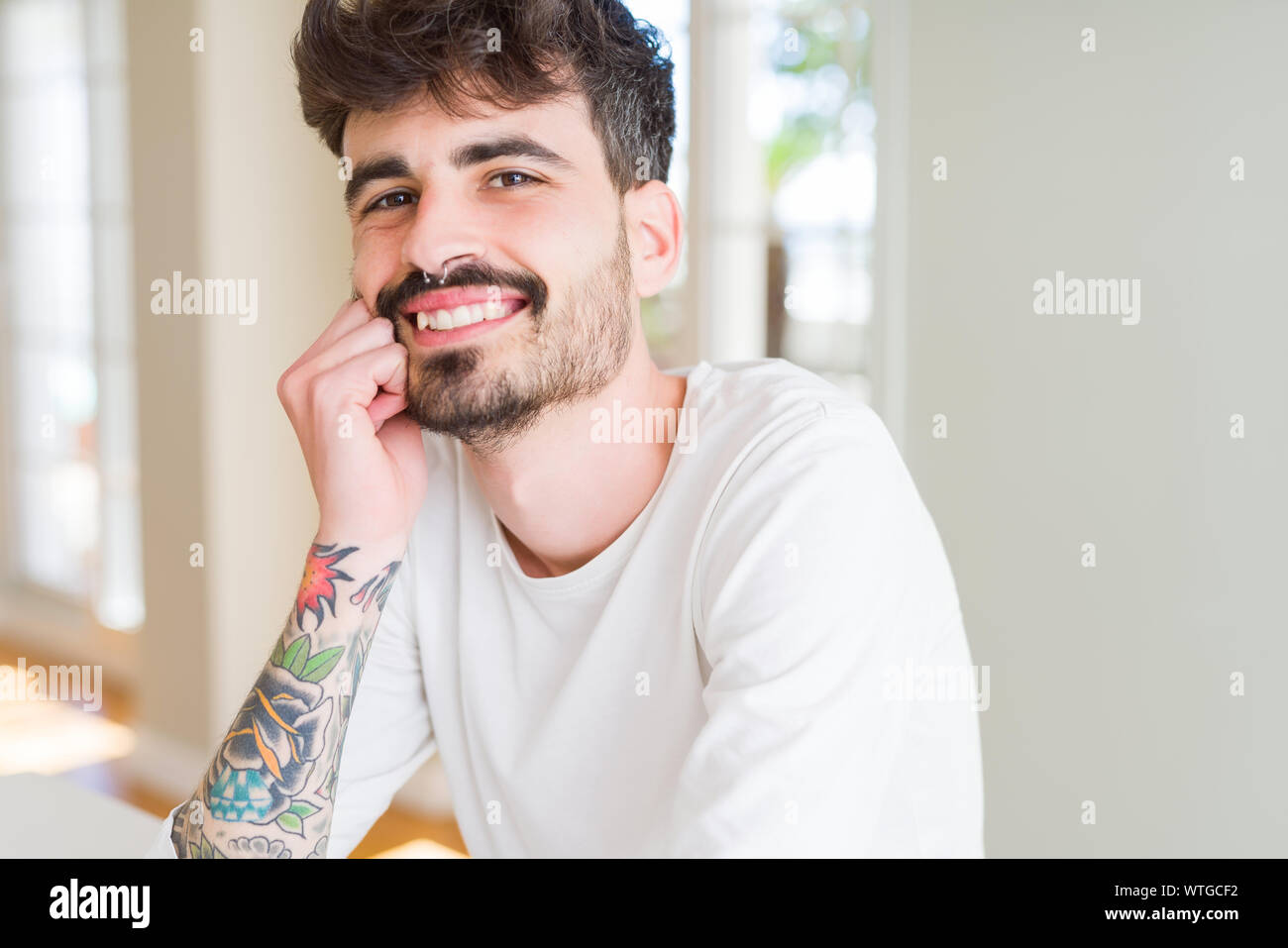 Handsome young man smiling cheerful at the camera with a big smile on ...