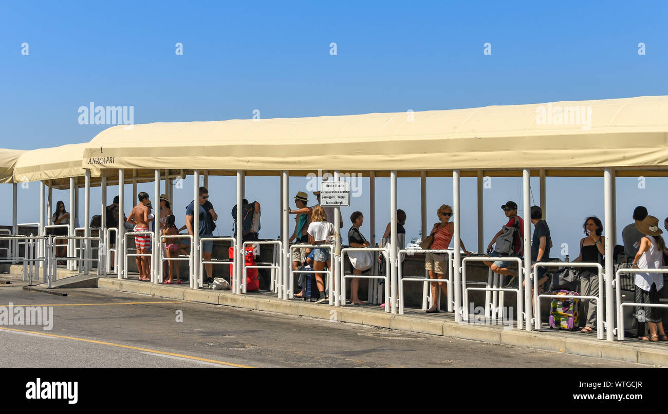ISLE OF CAPRI, ITALY - AUGUST 2019: People queuing at the bus stop at ...