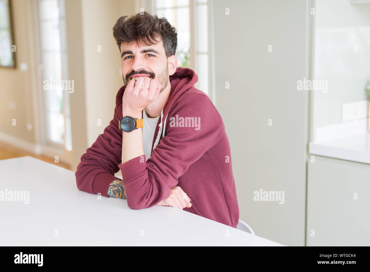 Handsome young man smiling cheerful at the camera with a big smile on ...