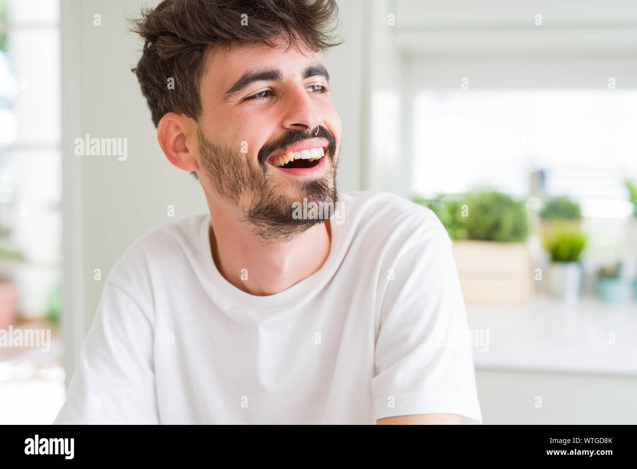 Handsome young man smiling cheerful at the camera with a big smile on ...