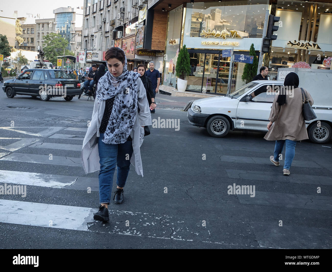 Tehran, Iran. 12th Sep, 2019. People cross an intersection on Valiasr ...